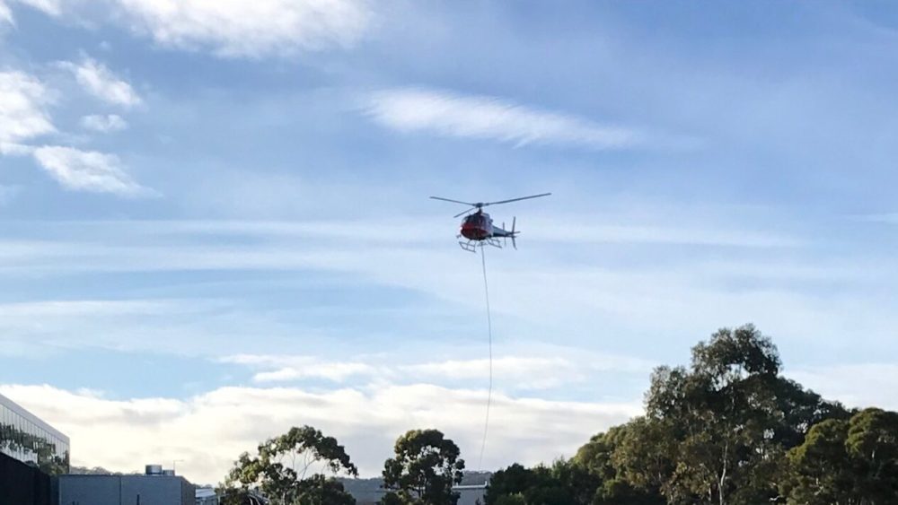 Helicopter transports 2,000 solar panels onto roof - Tonsley